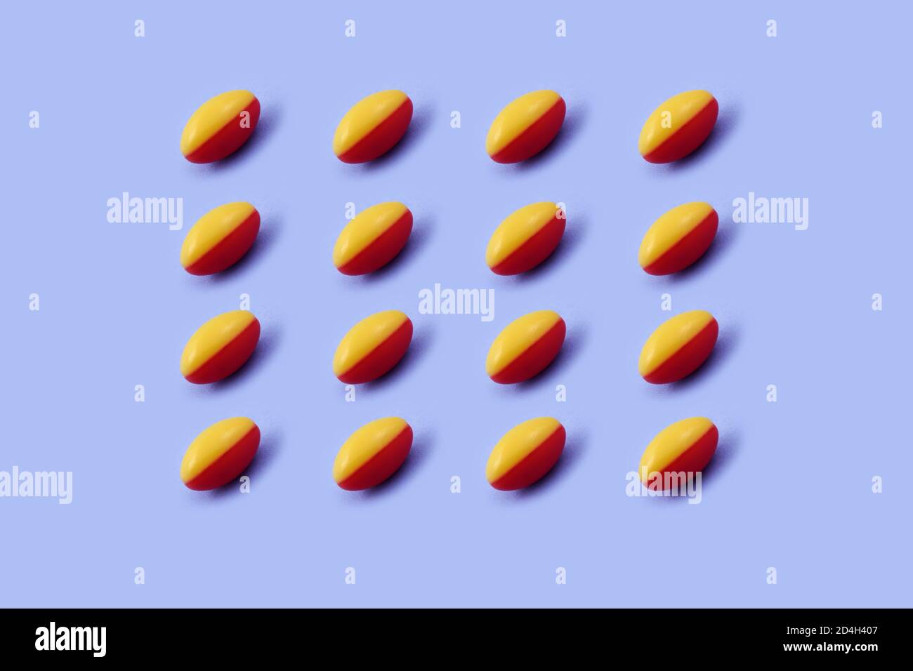 Red and yellow capsule Pharmaceutical medicine tablet on a Blue ...