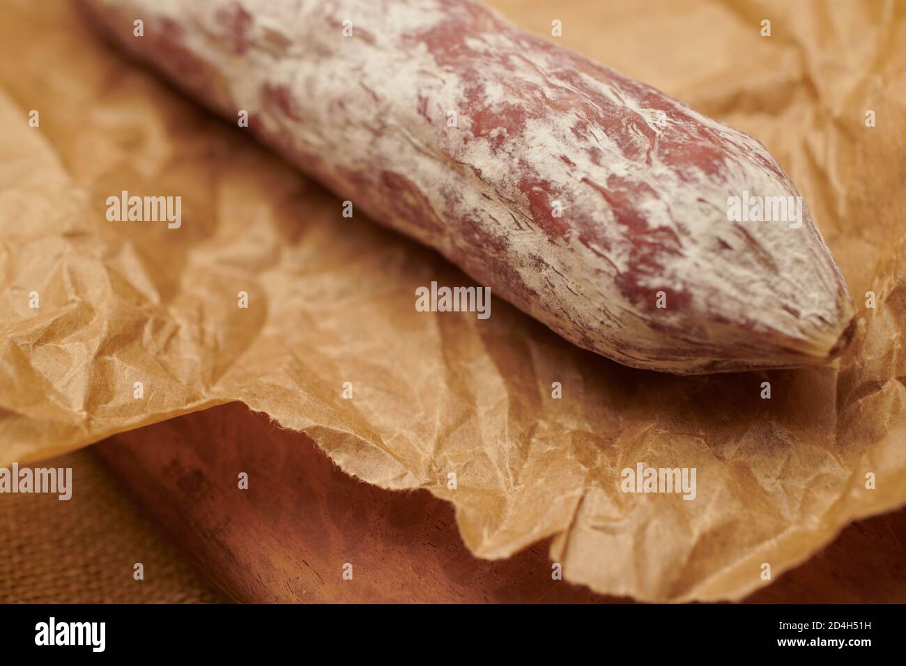 Salami on brown paper packaging Stock Photo - Alamy