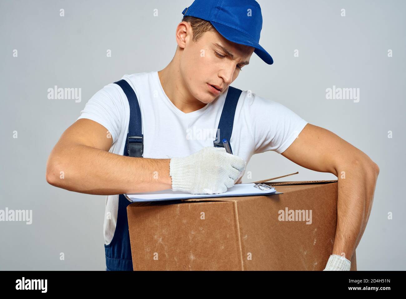 Man worker with box in hands delivery loading service packing service ...