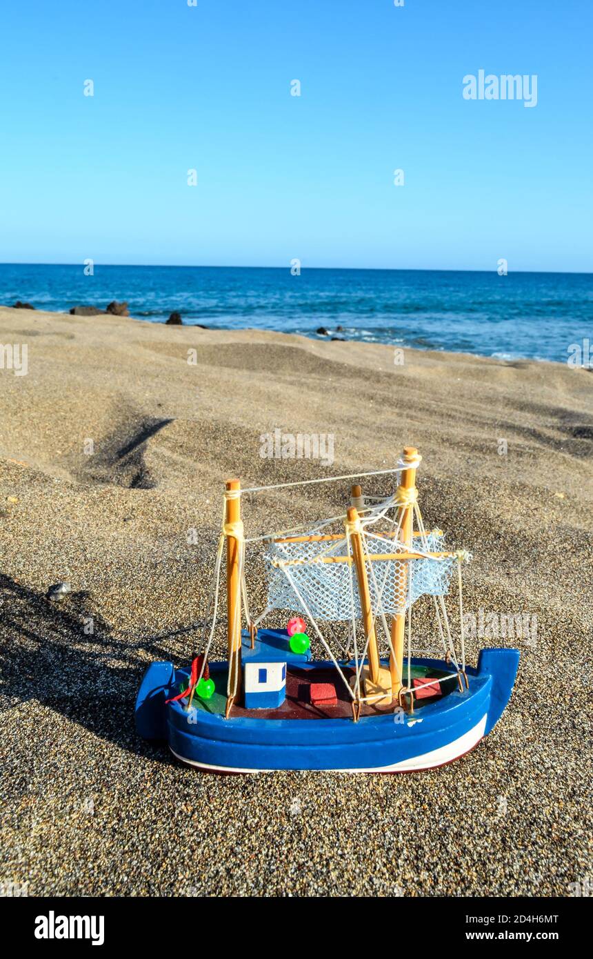 Toy Boat on the Sand Beach Stock Photo - Alamy
