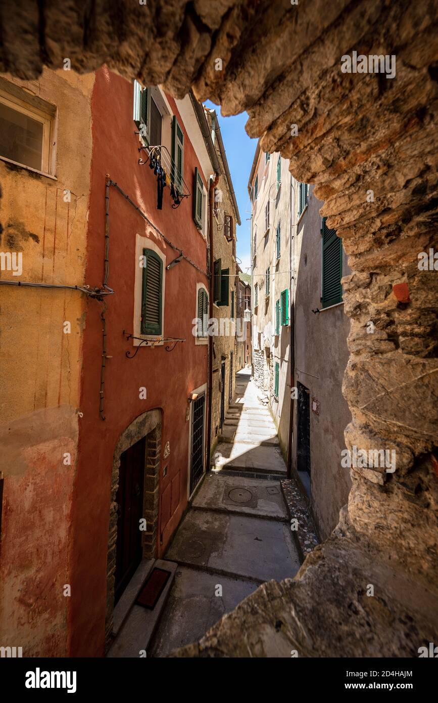 Narrow alley (carruggio or caruggio) in the small and ancient village ...