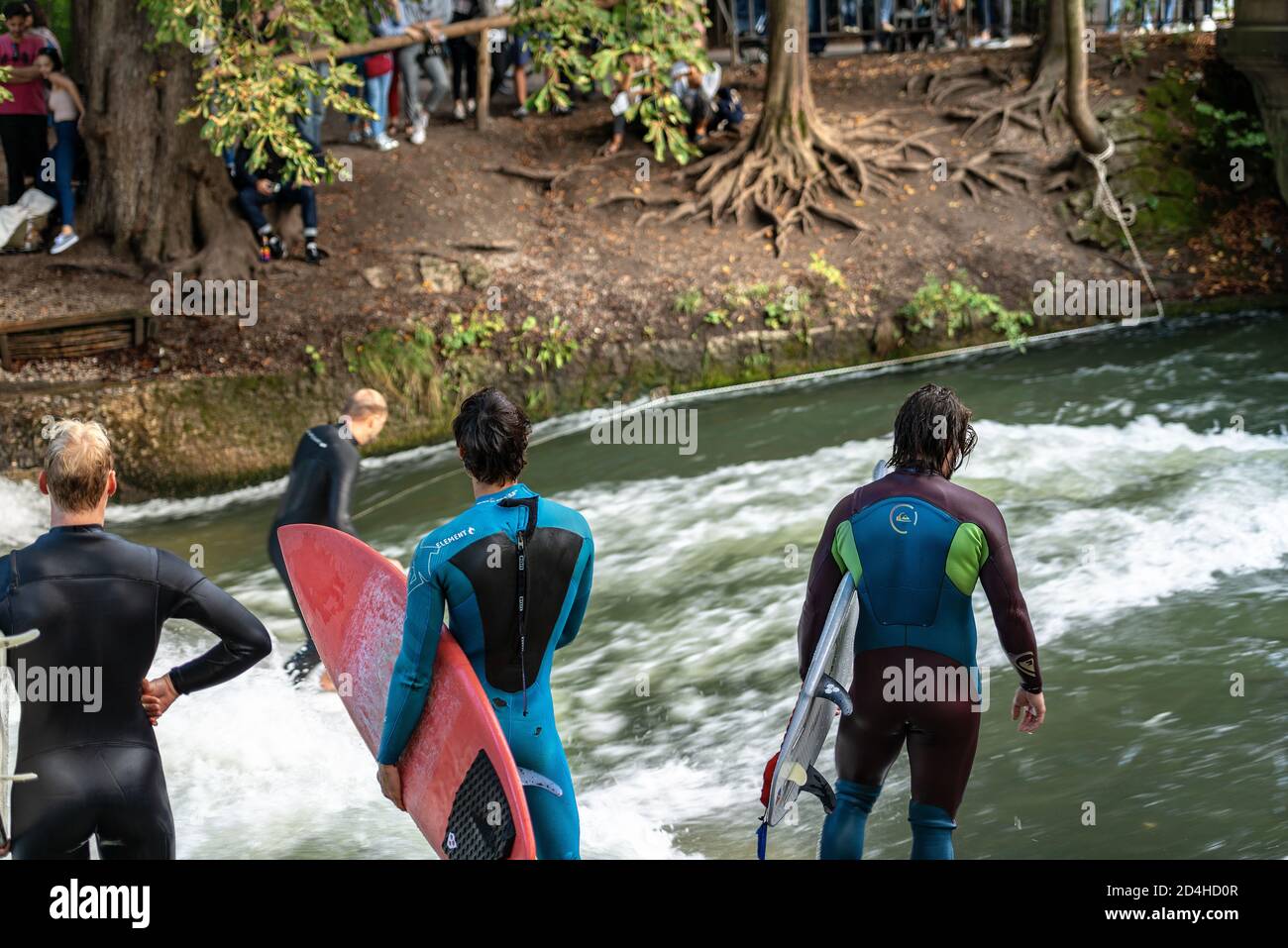 Man surfing in the waves of the Eisbach River in Munich. It forms a ...