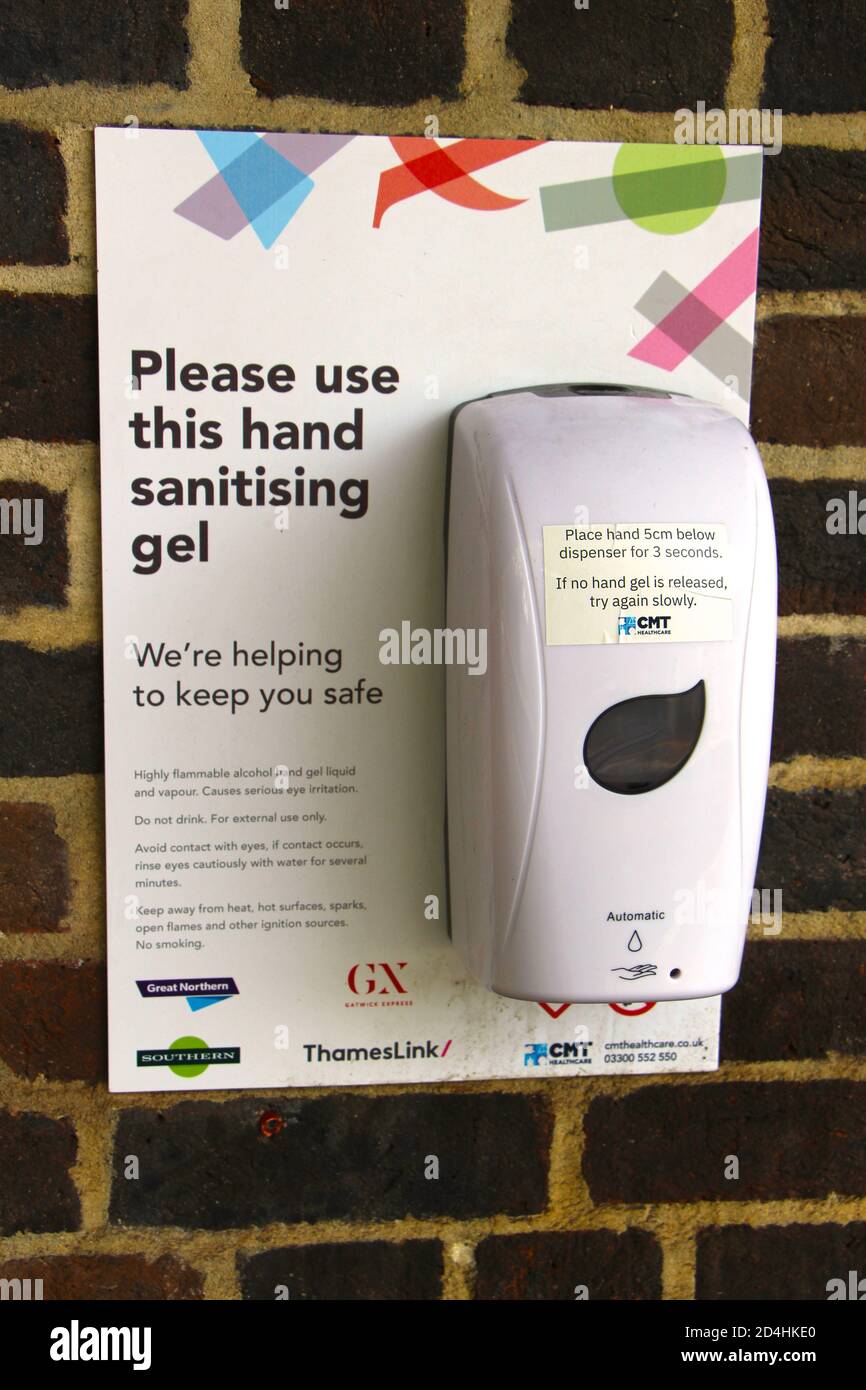 Sanitising gel dispenser on a brick wall at Riddlesdown railway station ...
