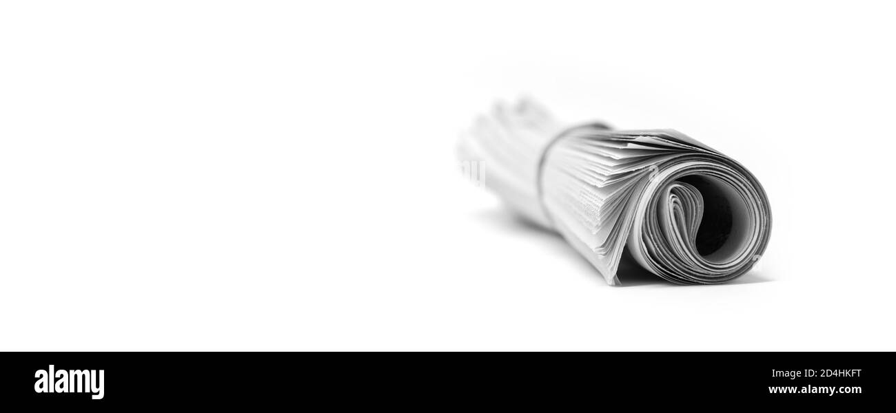 Rolled up newspaper isolated on white background Stock Photo - Alamy
