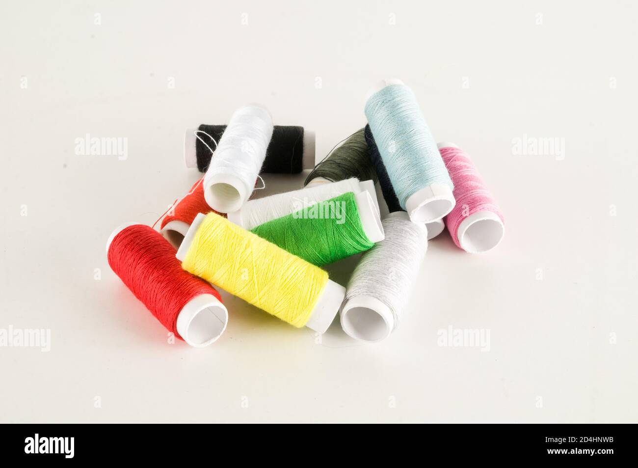 Colored sewing thread background Stock Photo - Alamy