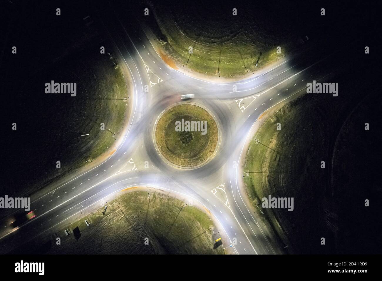 Streets with roundabout at night time light above drone view Stock ...