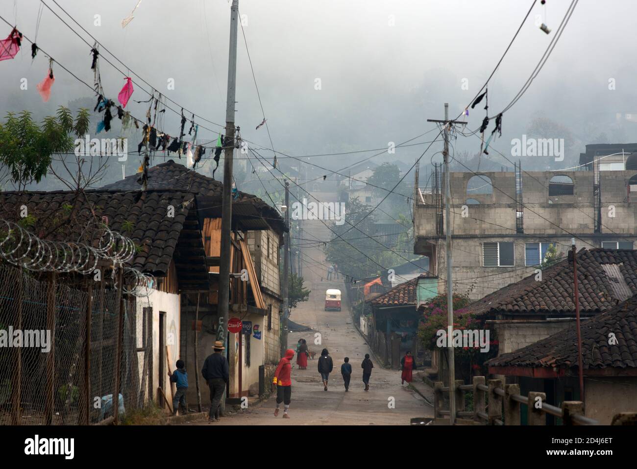 A typical street scene with people talking in a small, indigenous Ixil ...