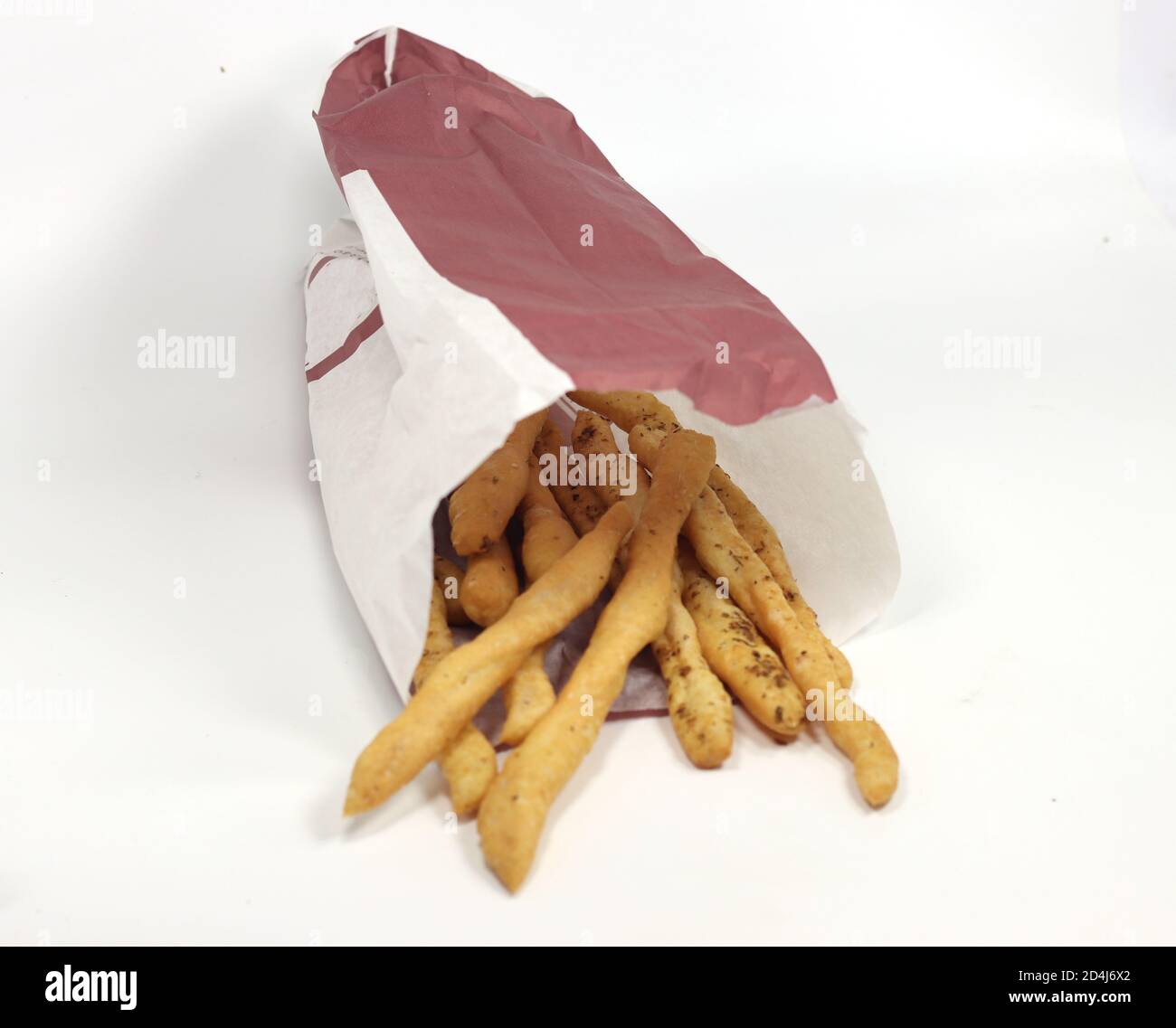 Closeup shot of fresh breadsticks in a paper package isolated on a ...