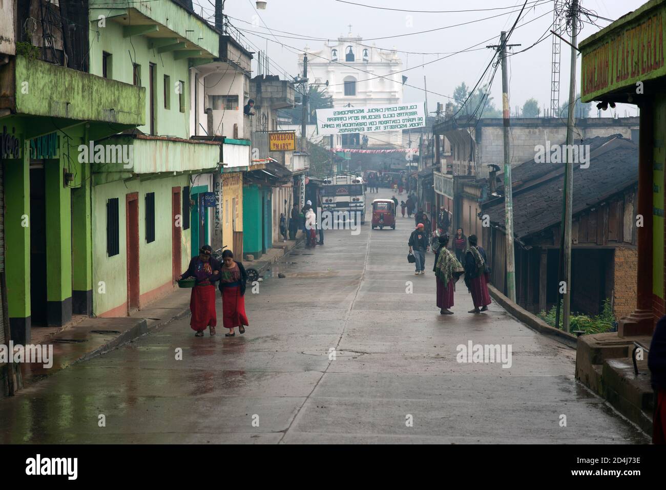 A typical street scene with people talking in a small, indigenous Ixil ...