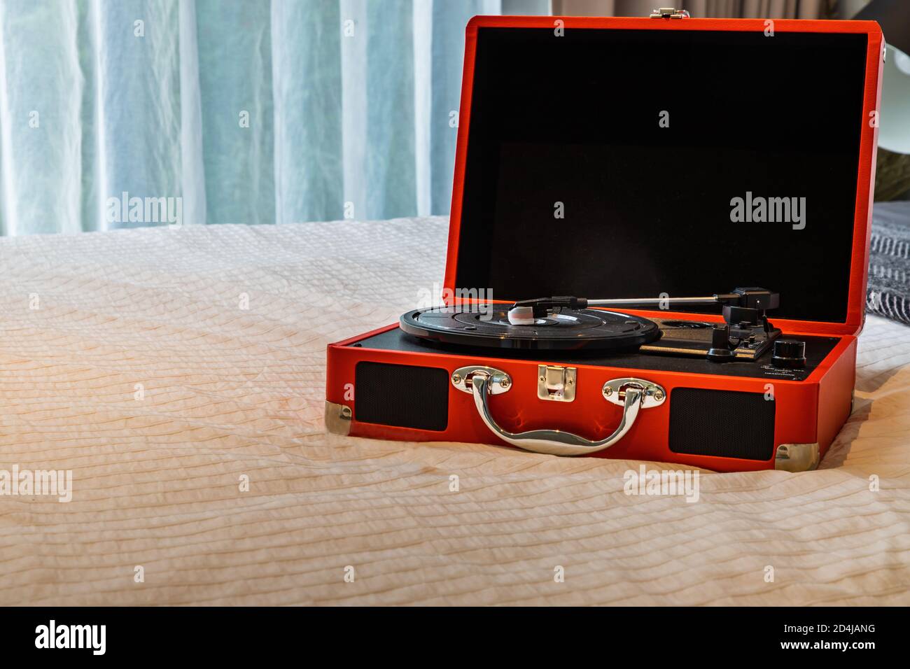 Portable turntable on white bed in bedroom. Selective focus Stock Photo ...
