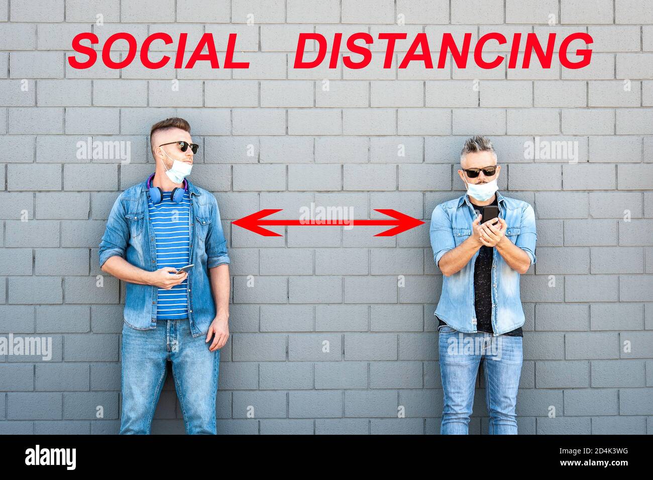 Two friends wearing lowered face protective masks using smart mobile ...