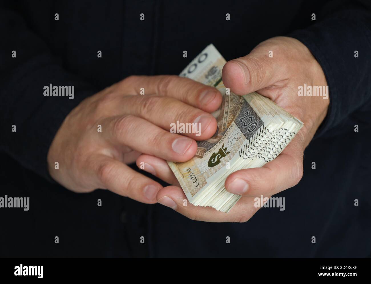 stack of large banknotes in the hands of a man Stock Photo - Alamy