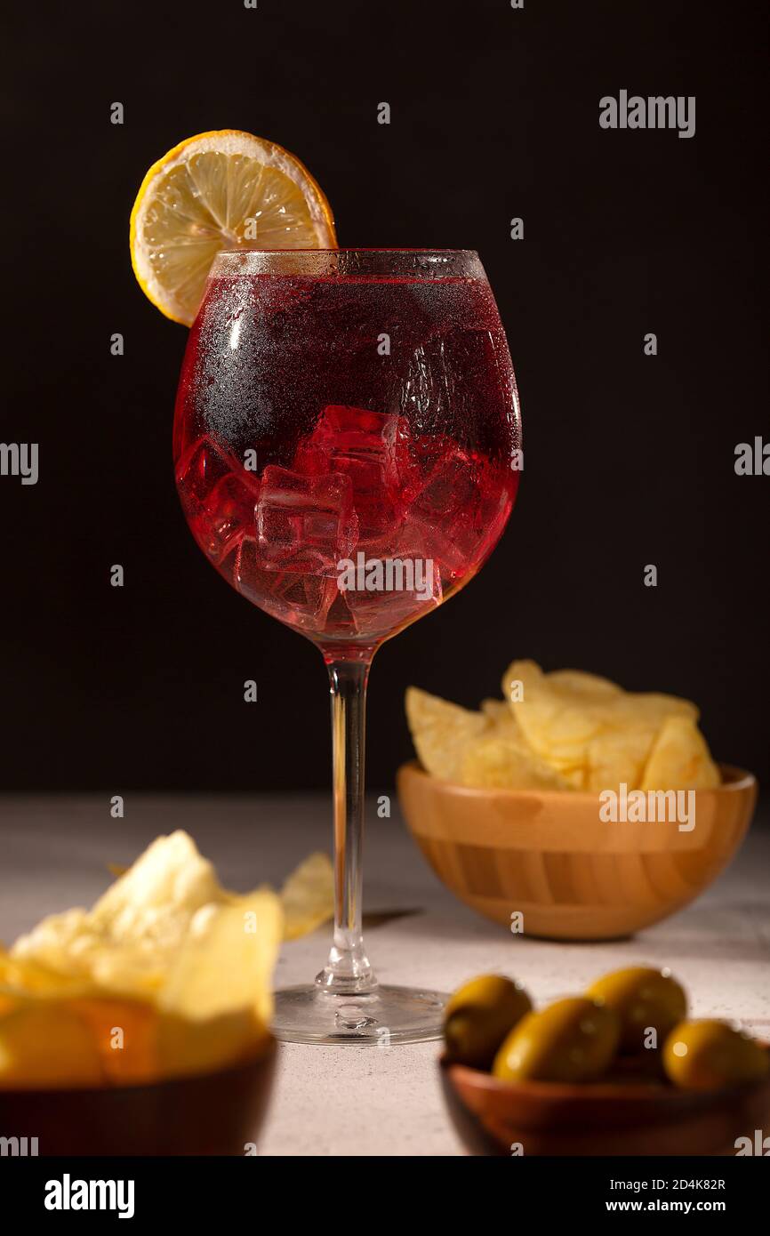 Typical aperitif with red wine and chips Stock Photo - Alamy