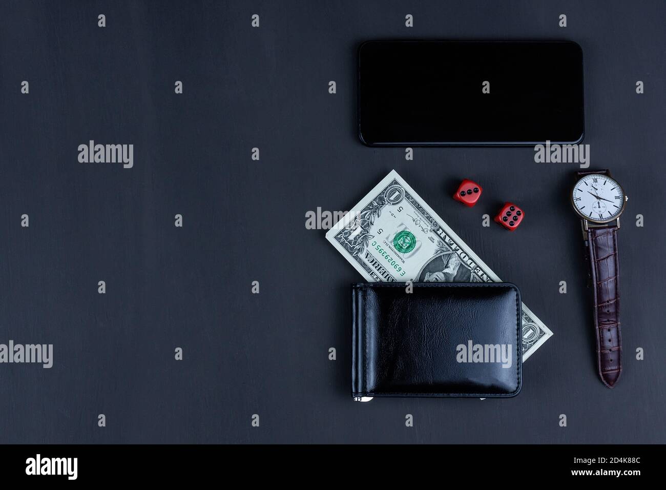 dice and wallet with a dollar on a black background, success of the ...