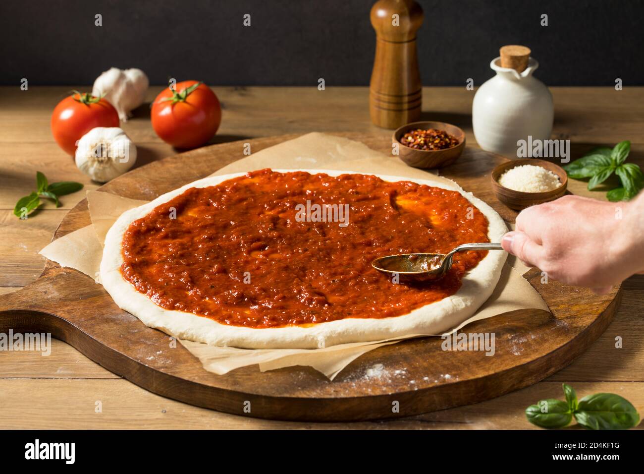 Preparing Homemade Uncooked Cheese PIzza with Sauce and Dough Stock ...