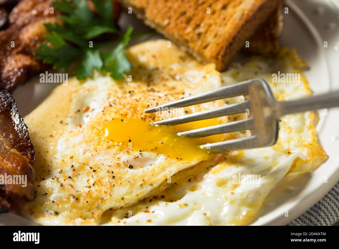 Homemade Over Easy Eggs with Bacon and Toast Stock Photo - Alamy