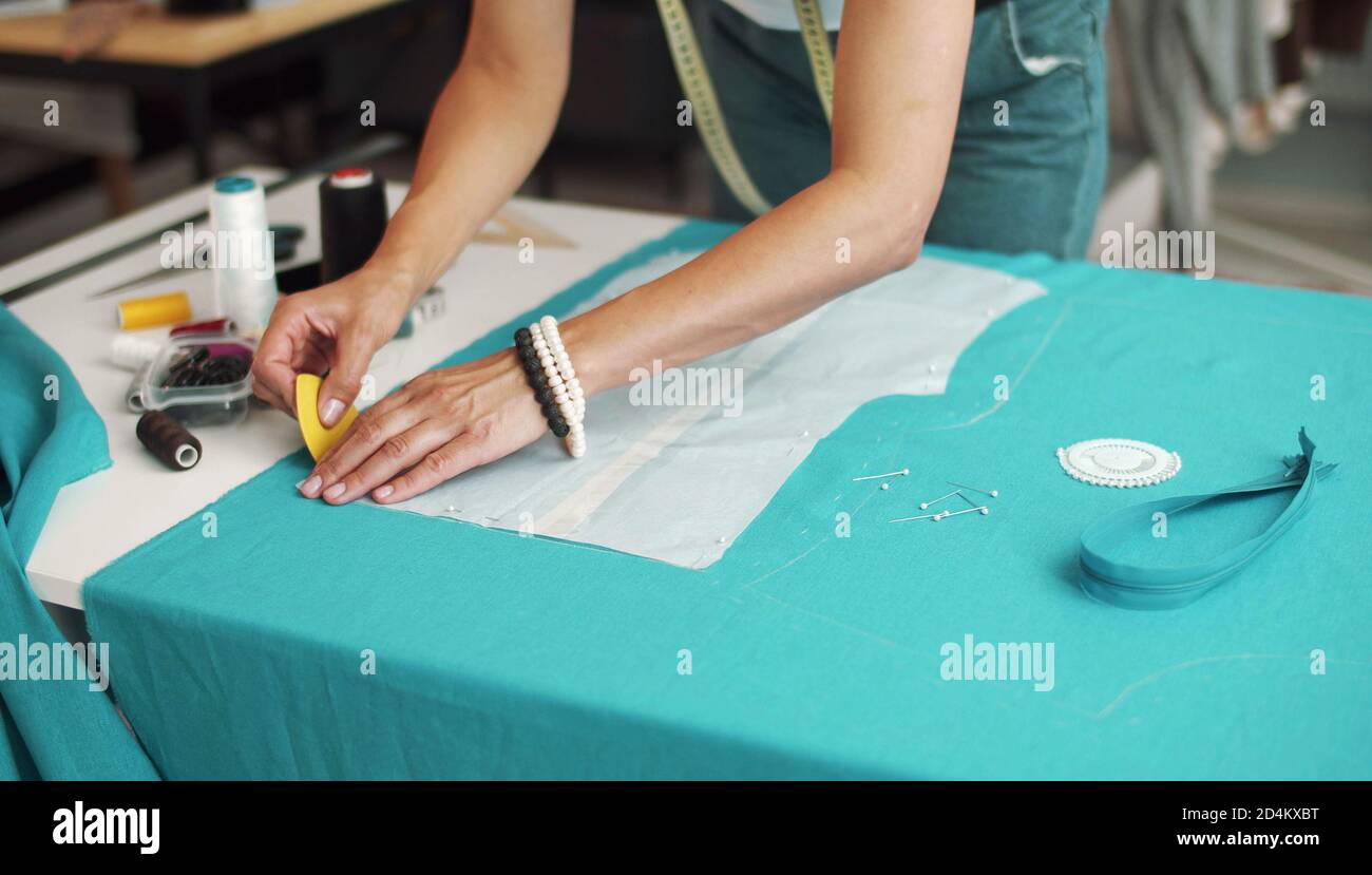 Tailor's hands tracing pattern Stock Photo - Alamy