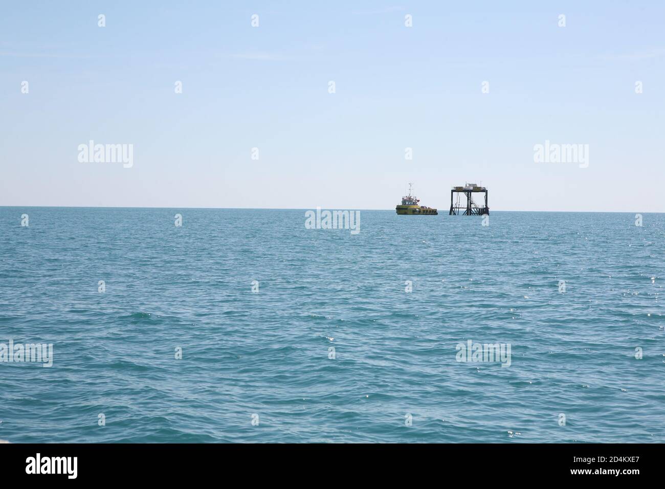 Marine platform and working boat Stock Photo - Alamy