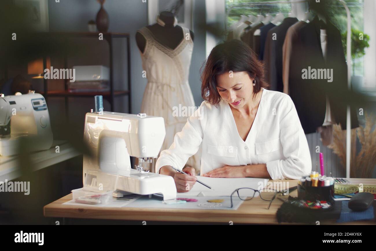 Woman fashion designer drawing sketch Stock Photo - Alamy