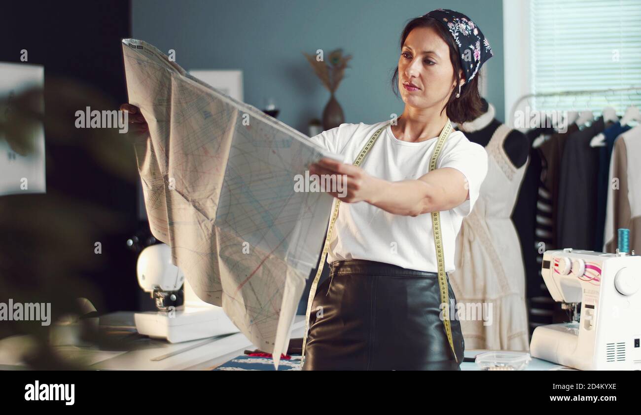 Designer looking sewing printing patterns Stock Photo - Alamy