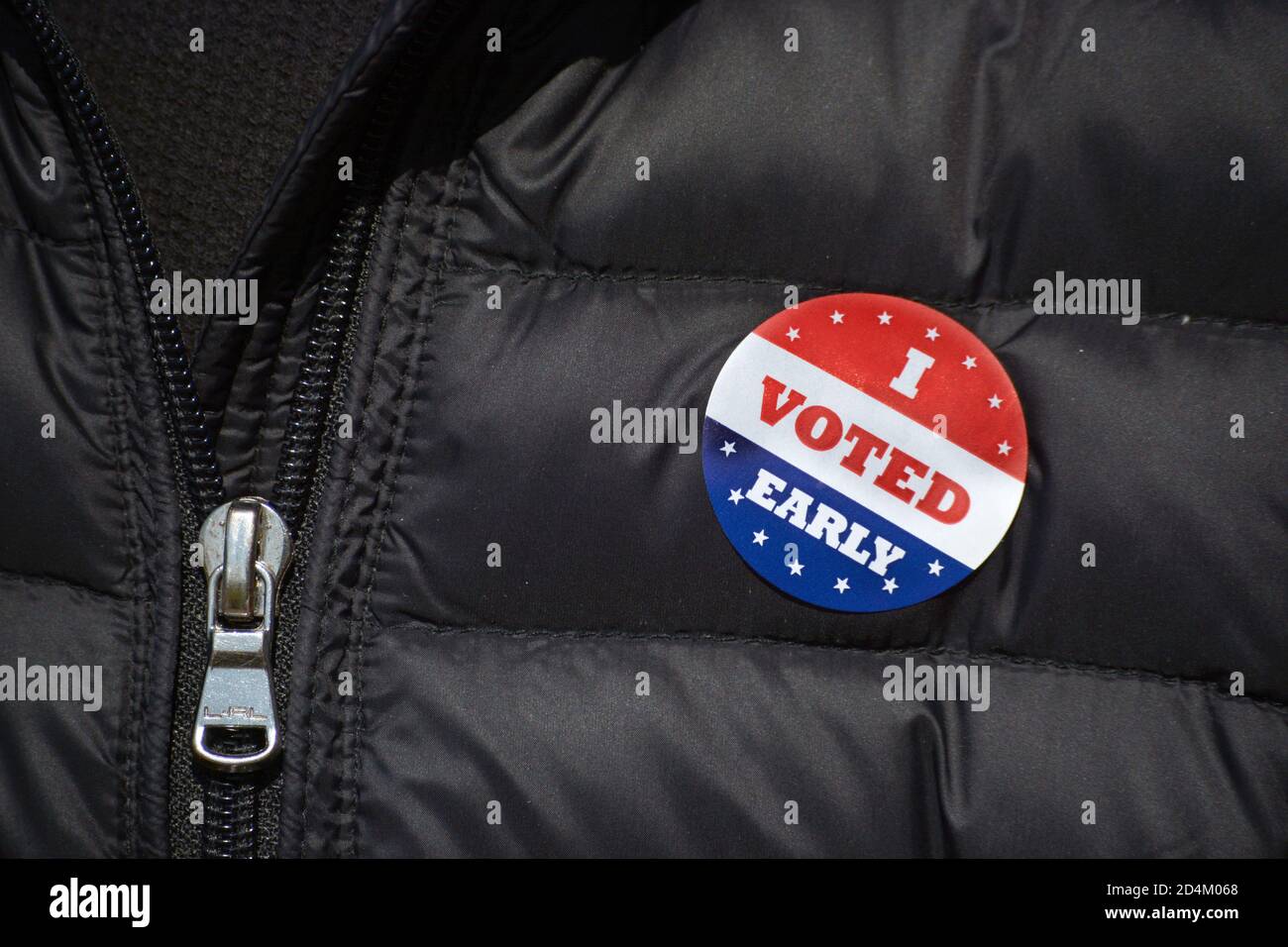 A woman wears an "I Voted Early" button on her jacket after voting in ...