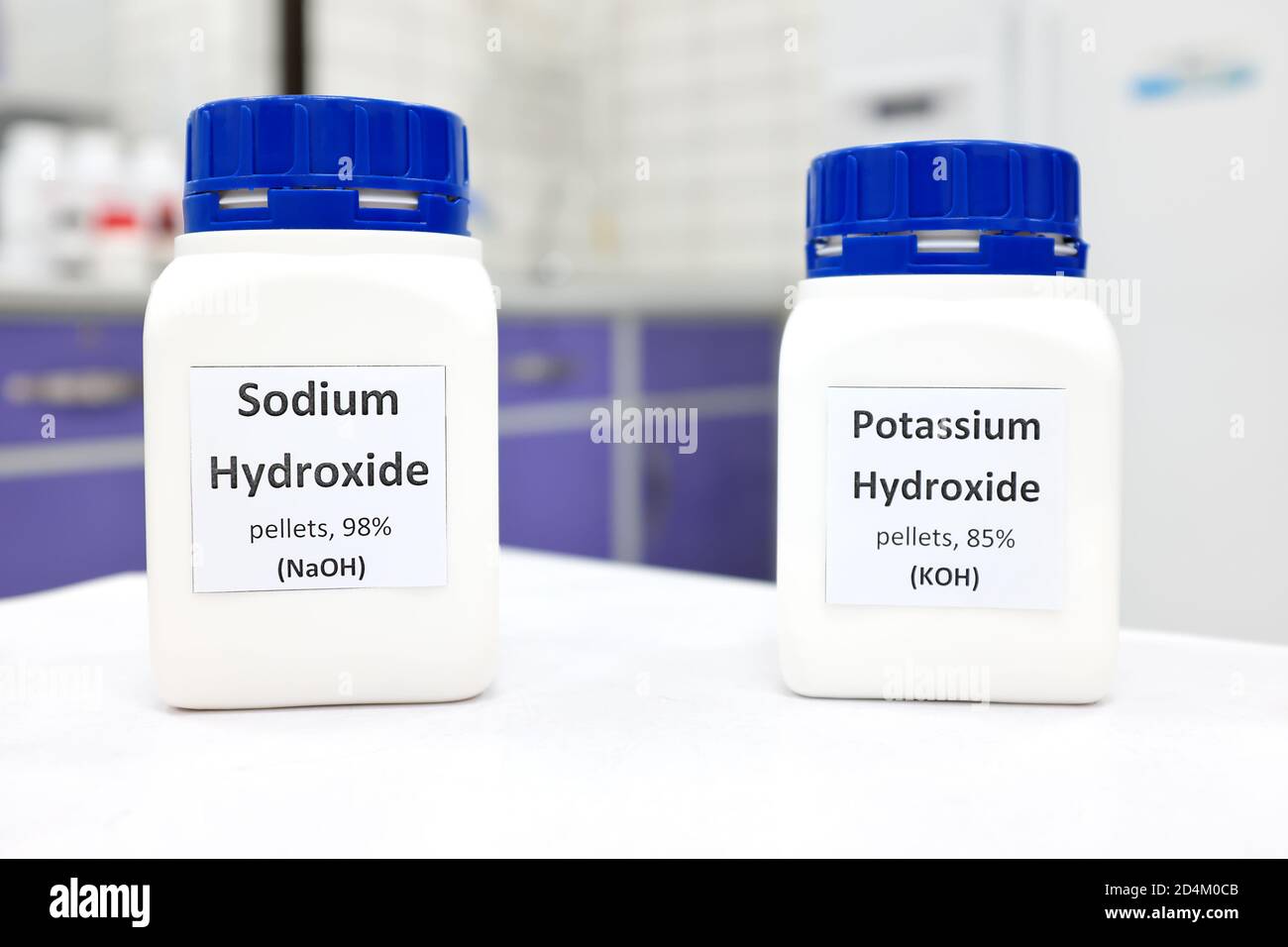 Selective focus of a bottle of pure sodium hydroxide and potassium ...