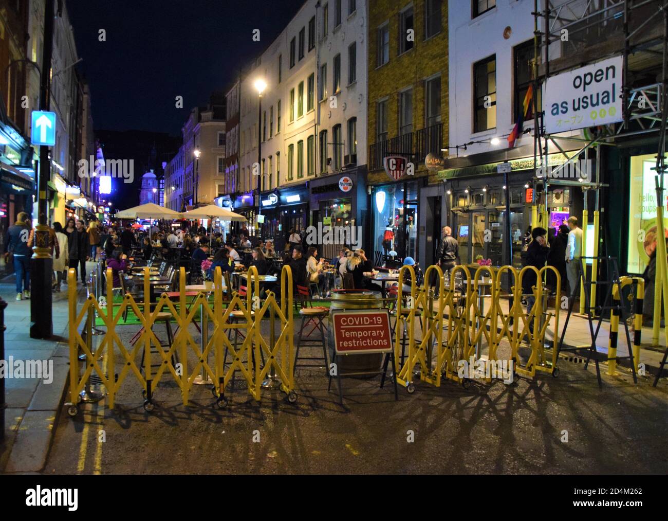 Covid-19 Temporary Restrictions sign and traffic barrier on Old Compton ...