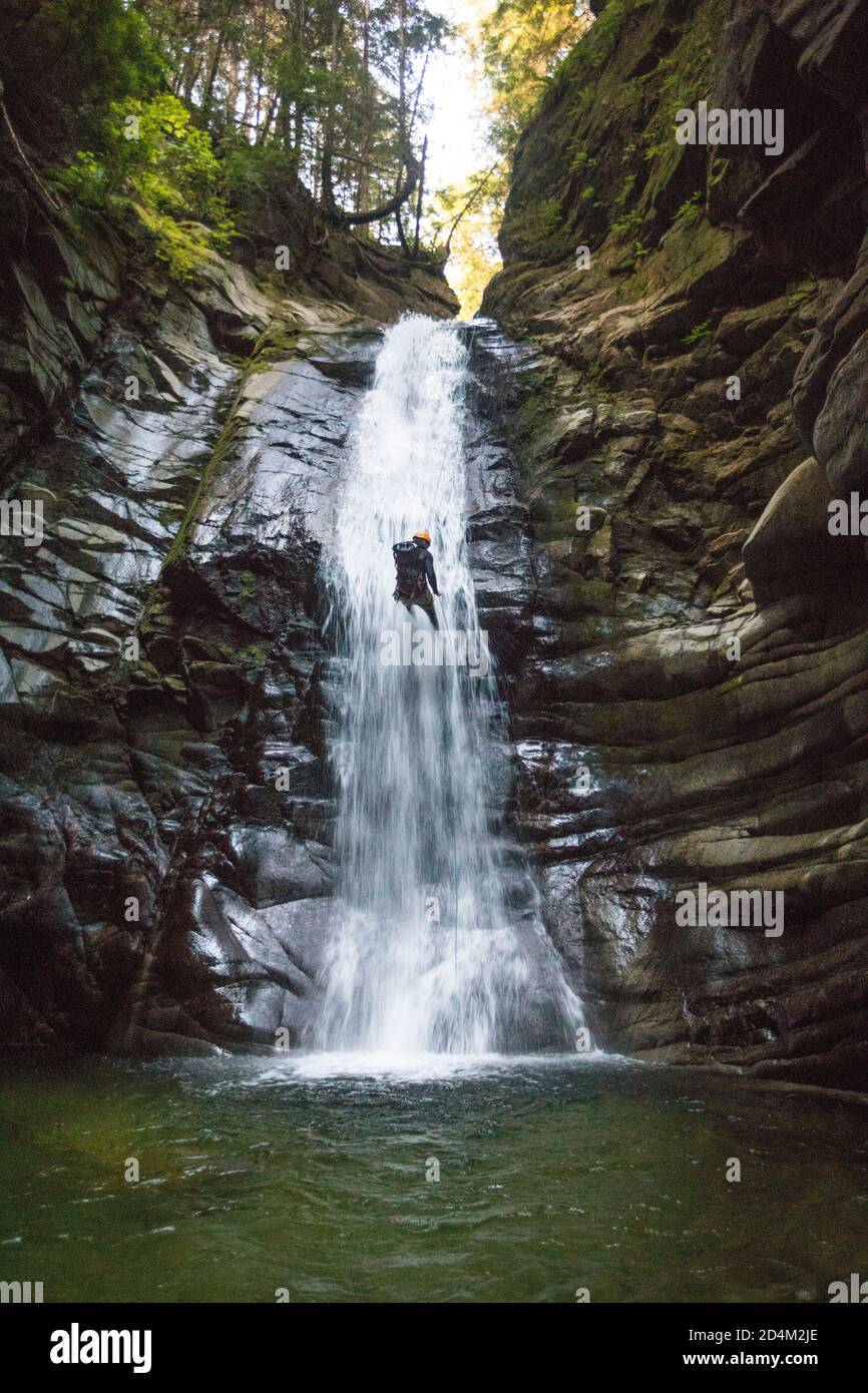 Brave man rappelling down waterfall in Cypress Canyon Stock Photo - Alamy