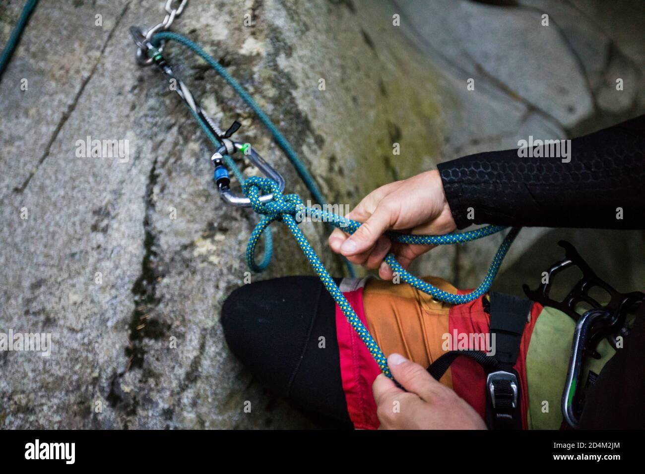 Detail view of climber tying rope for rappel, bolted route in canyon ...