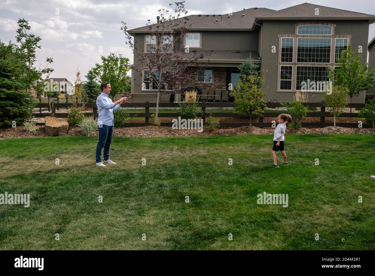 Father and Son playing catch in the backyard Stock Photo - Alamy