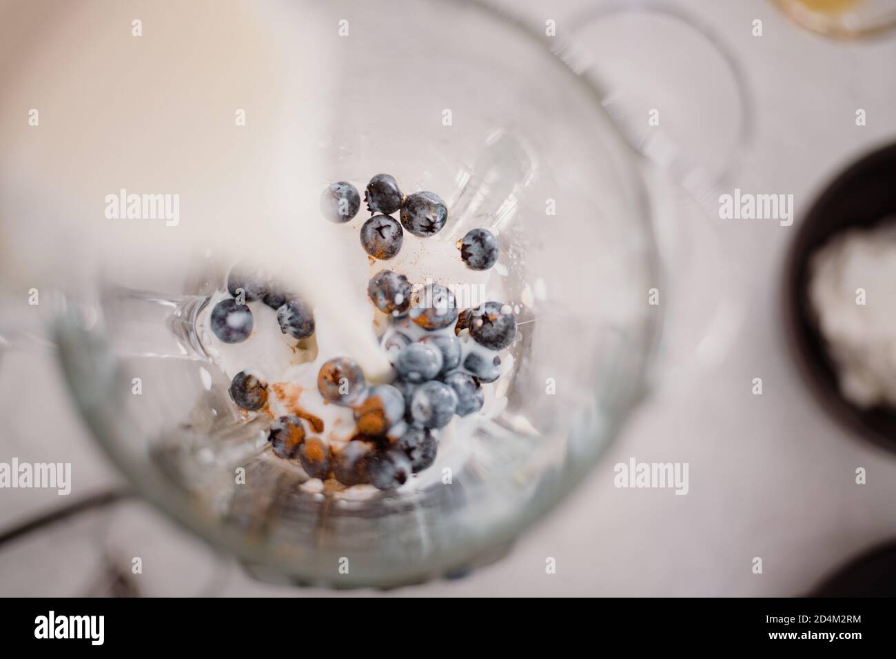 top down view of milk pouring into blender for blueberry smoothie Stock ...