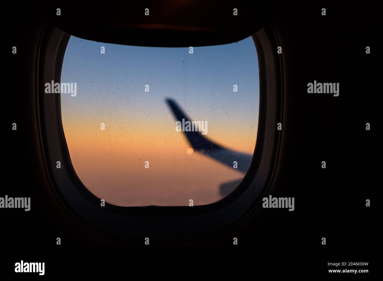 view out airplane window during flight of wing at sunset Stock Photo ...