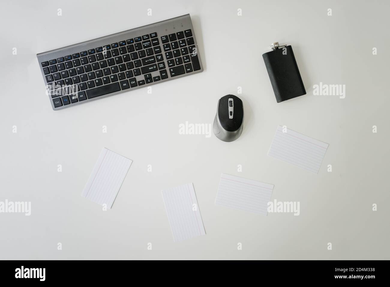 keyboard, mouse, index cards, and flask on white desk Stock Photo - Alamy