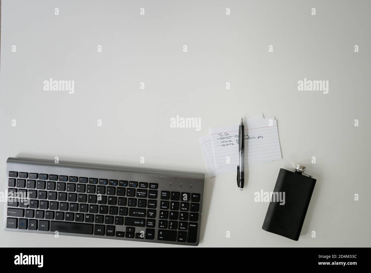 keyboard, pen, to-do list, and flask on white desk Stock Photo - Alamy