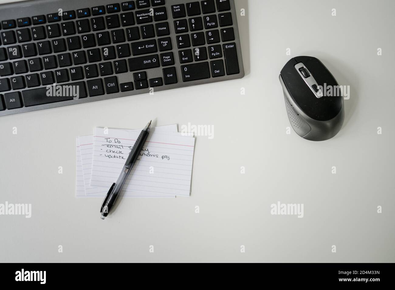 keyboard, mouse, to-do list, pen on white desk Stock Photo - Alamy