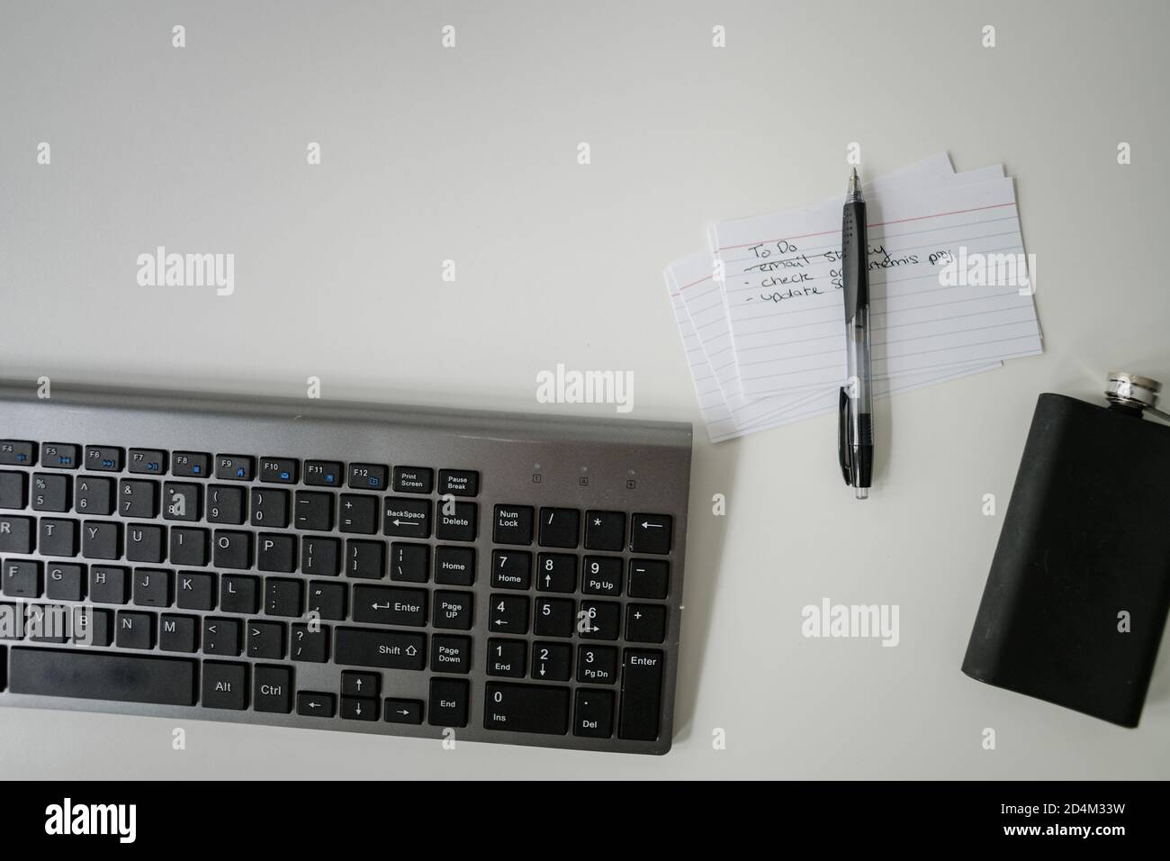 keyboard, pen, to-do list, and flask on white desk Stock Photo - Alamy