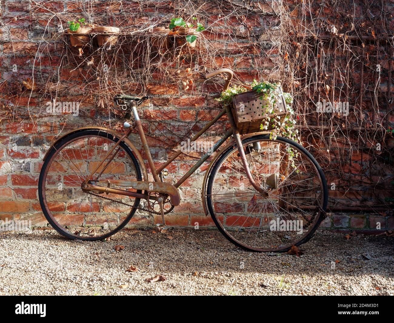 Old rustic Bike leaning on Red Brick Wall Stock Photo - Alamy