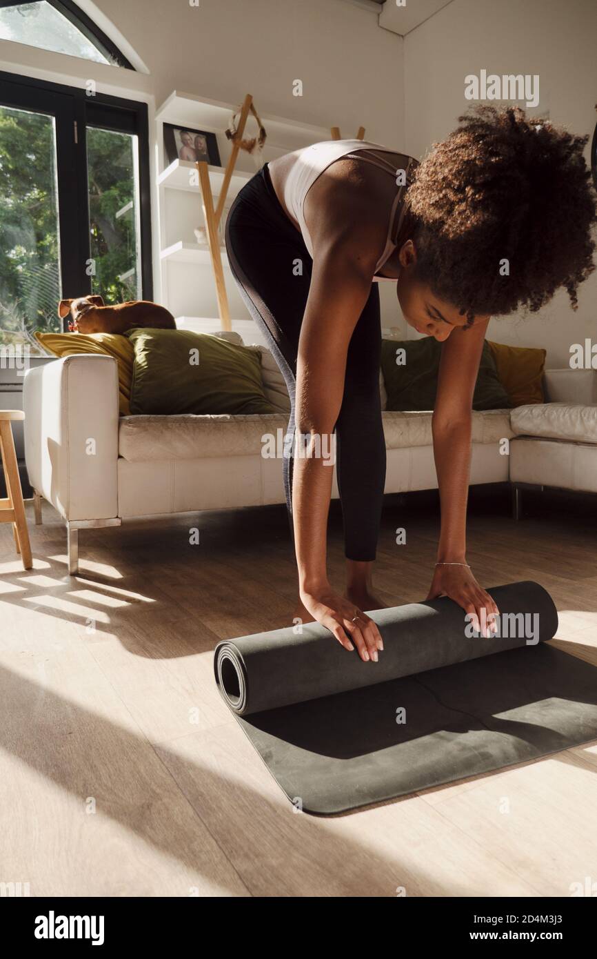 Beautiful African American female stretching before exercise routine ...