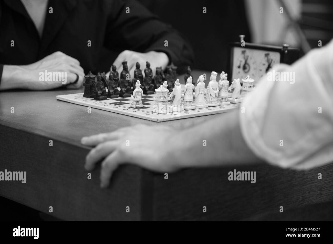 Grayscale closeup shot of people playing chess Stock Photo - Alamy