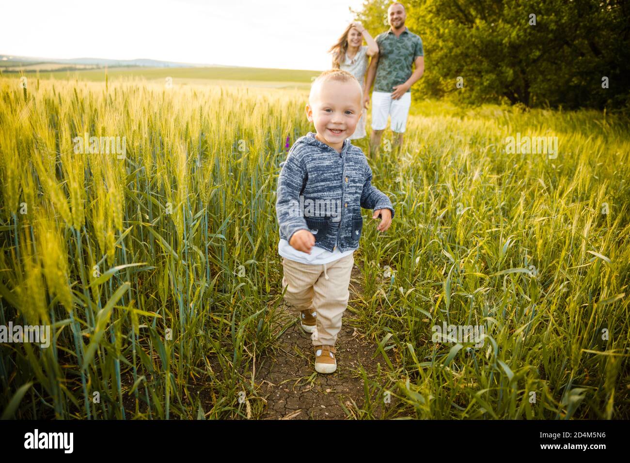 Child boy runs across a green field Stock Photo - Alamy