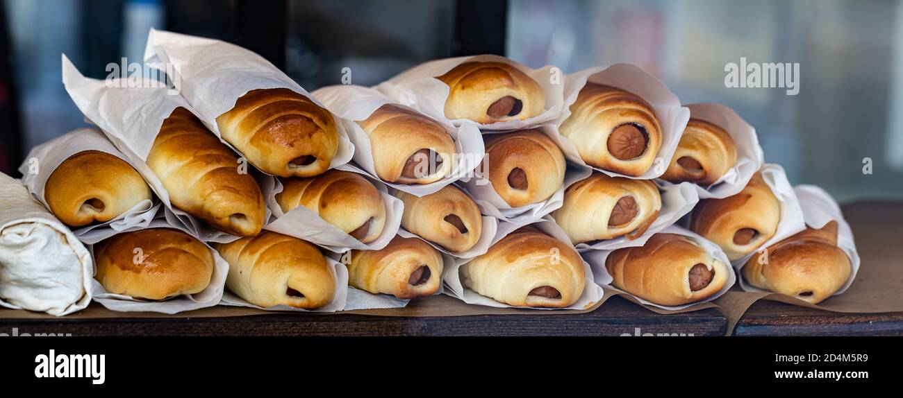 Freshly baked tasty sausage rolls laid out in a row, fast food ...