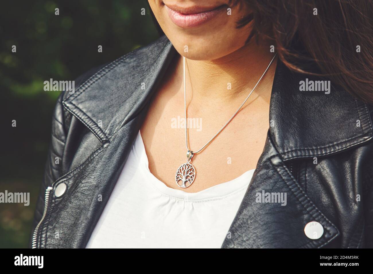 Female neckline wearing tiny silver chain with silver pendant in the ...