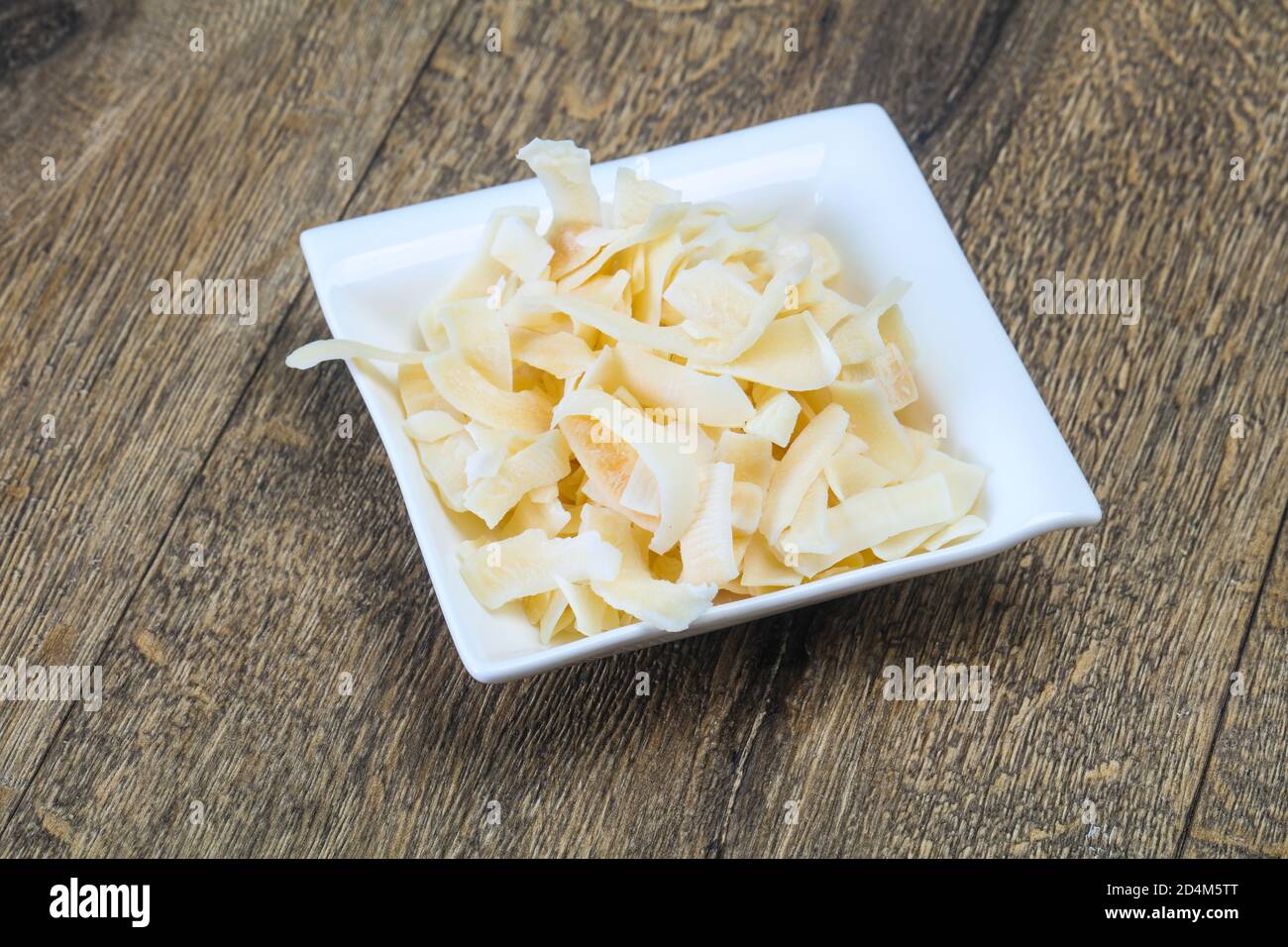 Coconut dry chips snack in the bowl Stock Photo - Alamy
