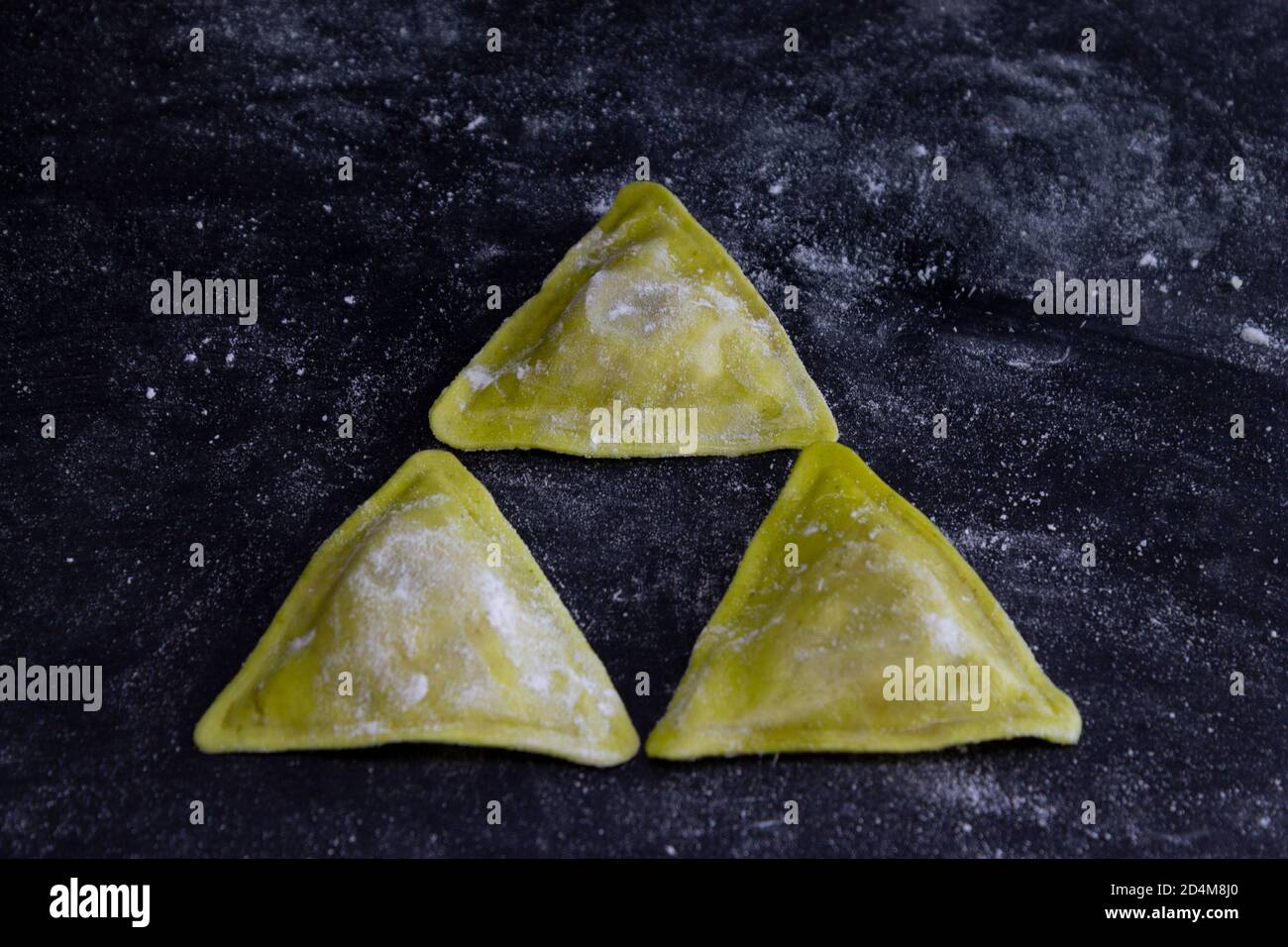 Fresh Triangle Ravioli on floury dark background Stock Photo - Alamy