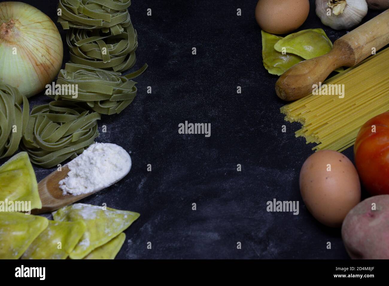 Pasta background with spaghetti , ravioli,eggs,onion,potato,garlic and ...