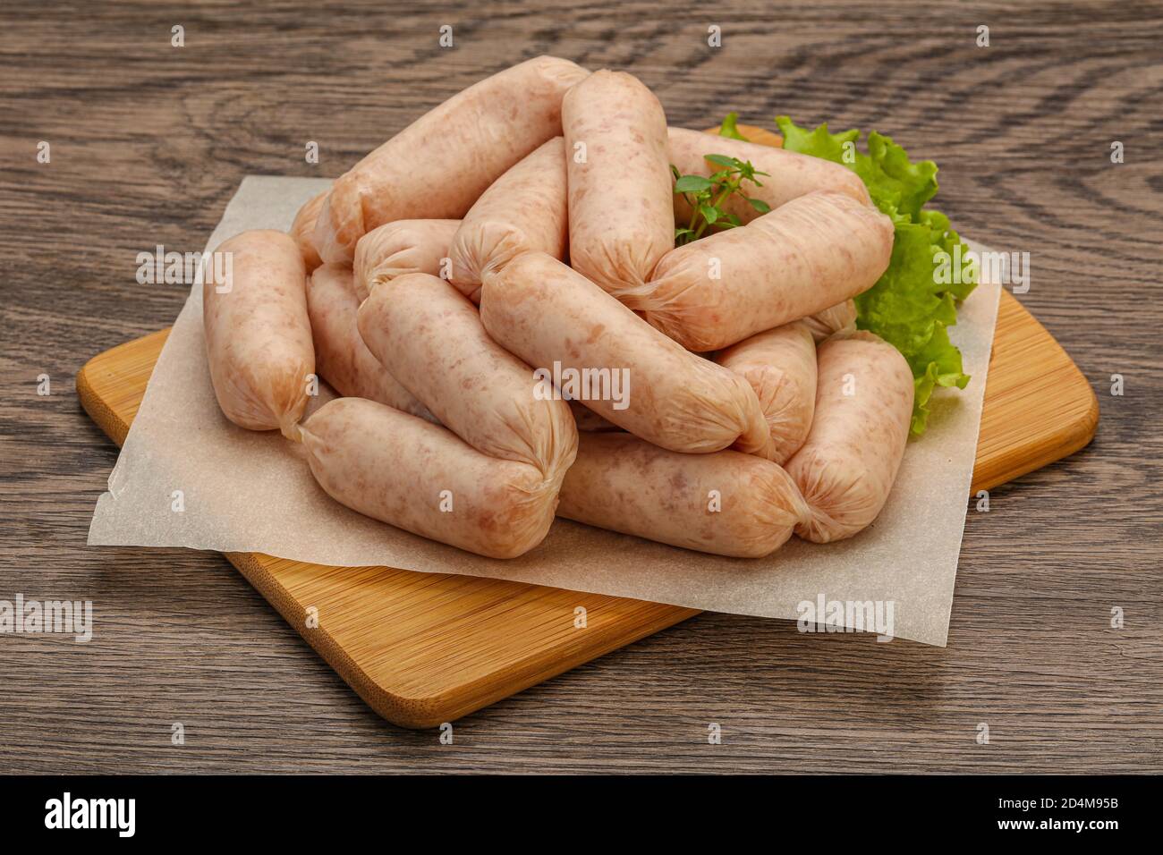 Raw natural chicken baby sausages for roast Stock Photo - Alamy