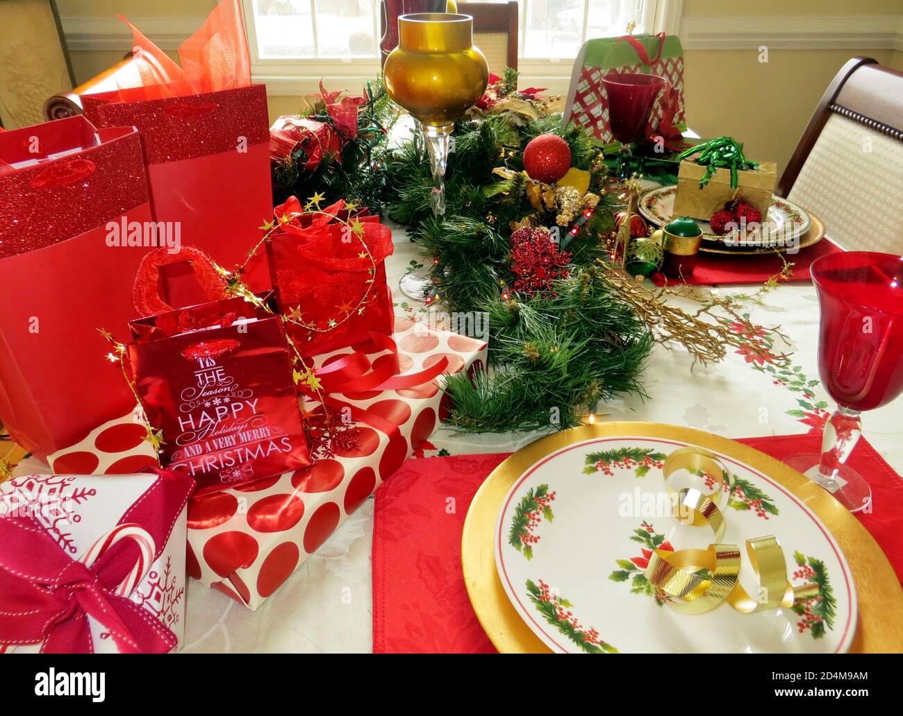 Gifts on a dining room table decorated for Christmas Stock Photo - Alamy