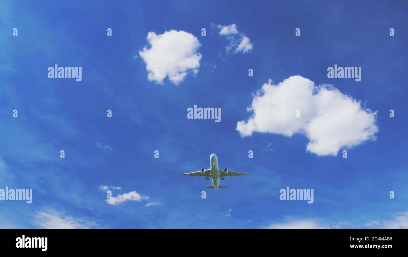 airplane in the blue sky with clouds, view from below of flying ...