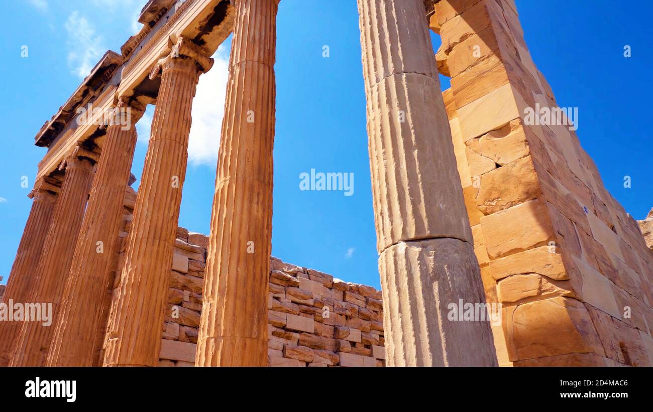 Ancient Greek temple columns against the blue sky, low angle view ...