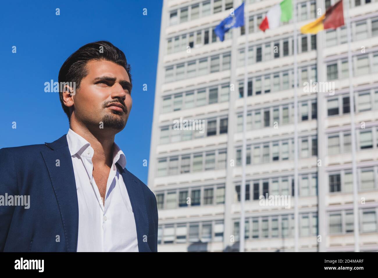 Businessman with white shirt and jacket. Modern building on the ...